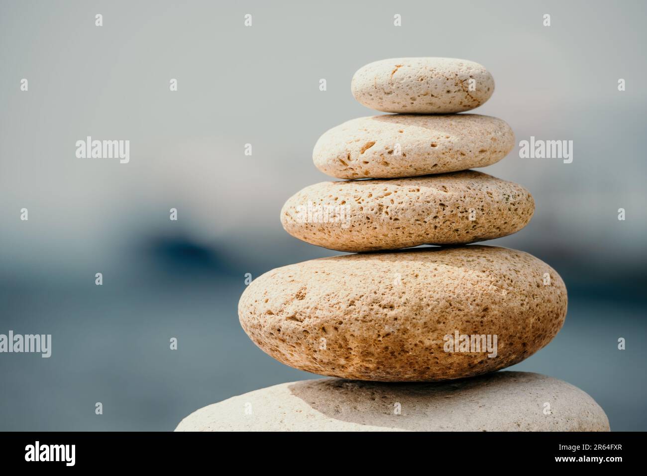balanced rock pyramid on the pebbled beach is a study in harmony and ...