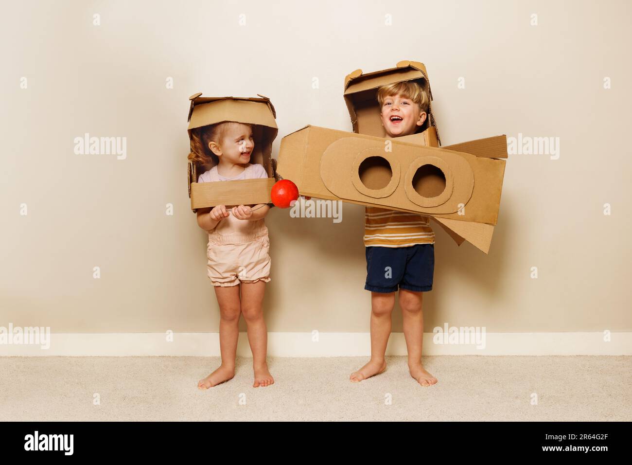 Kids with cardboard rocket and helmets hold red planet model Stock ...