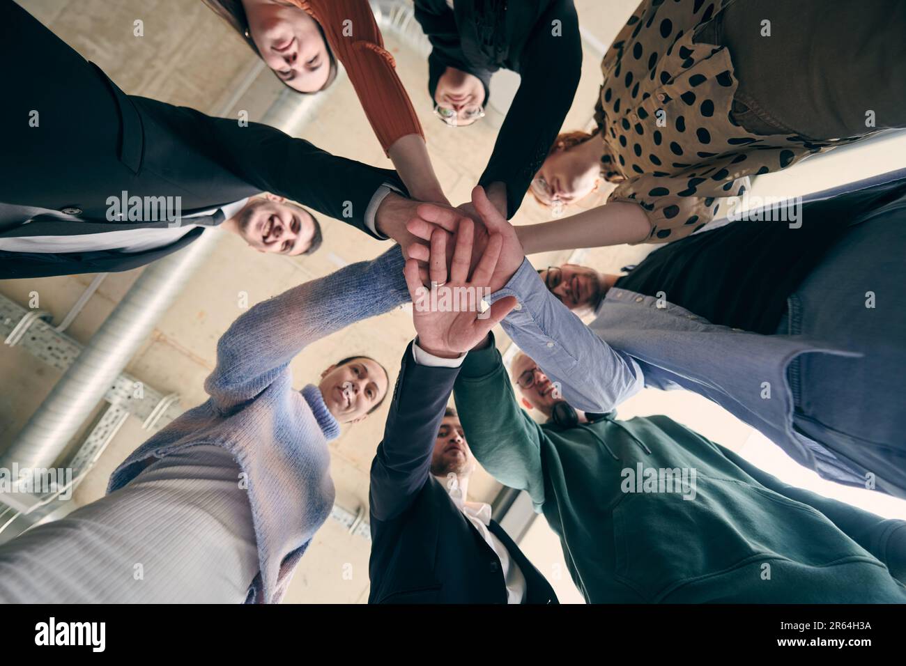 A group of businessmen holding hands together to symbolize unity and ...