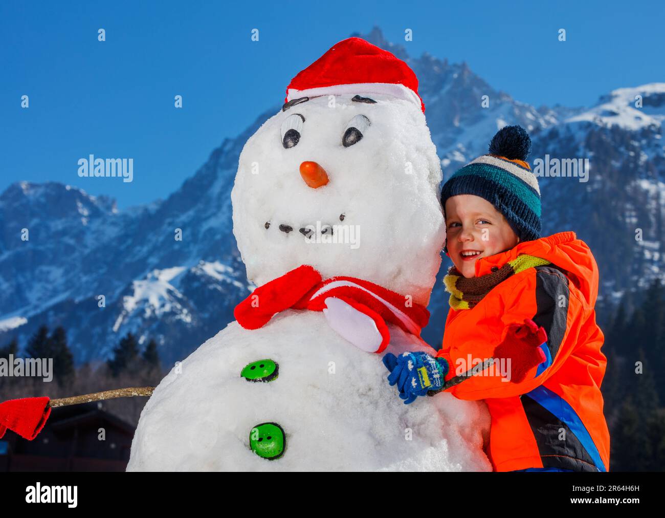 Little boy play and hug cute snowman with stunning eyes Stock Photo - Alamy