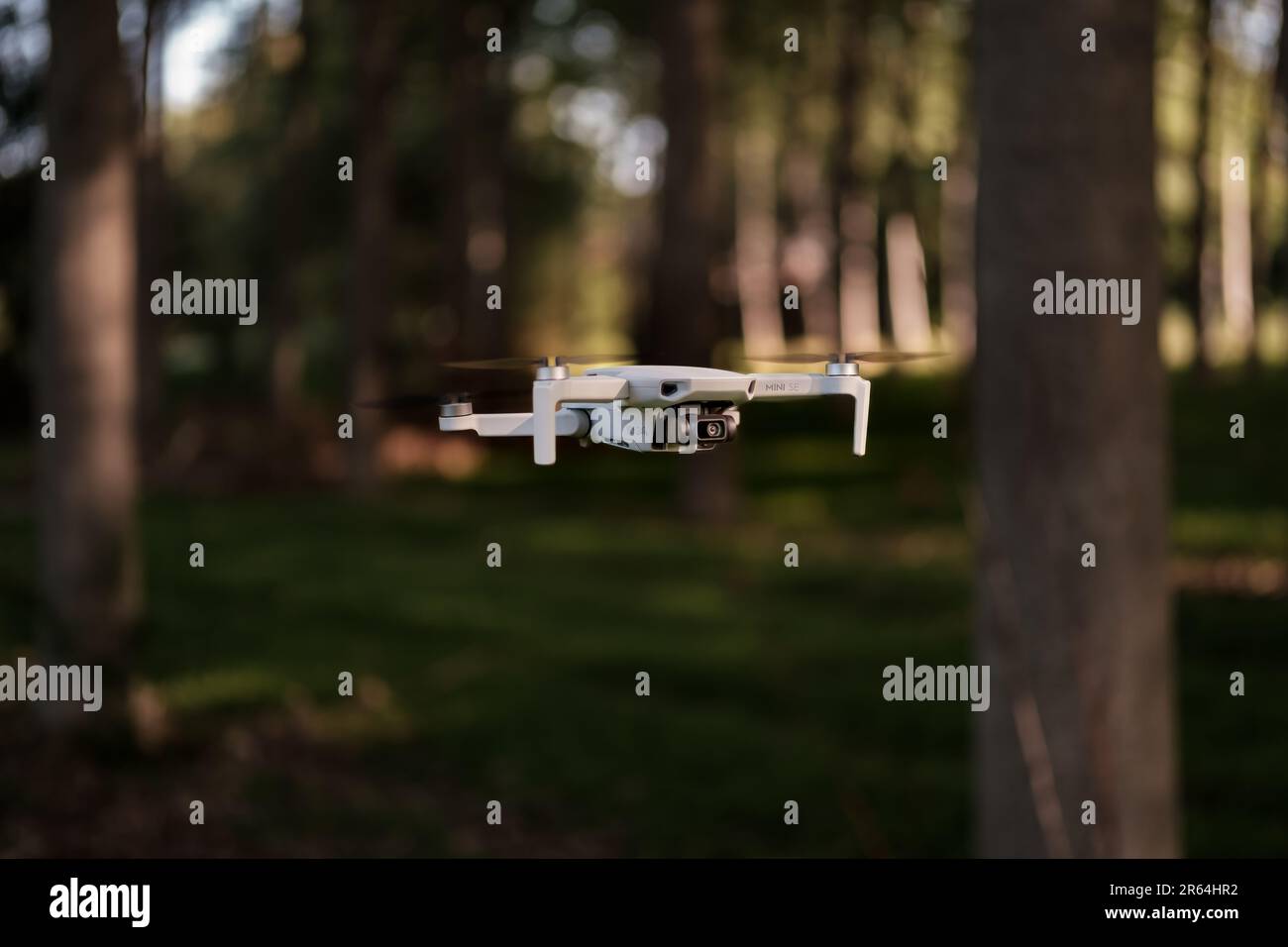 A miniature unmanned aerial vehicle (UAV) flying over a verdant grassy ...