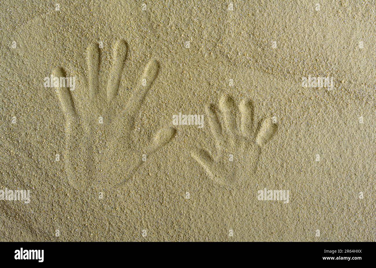 Handprints of an adult and a child in the sand Stock Photo - Alamy
