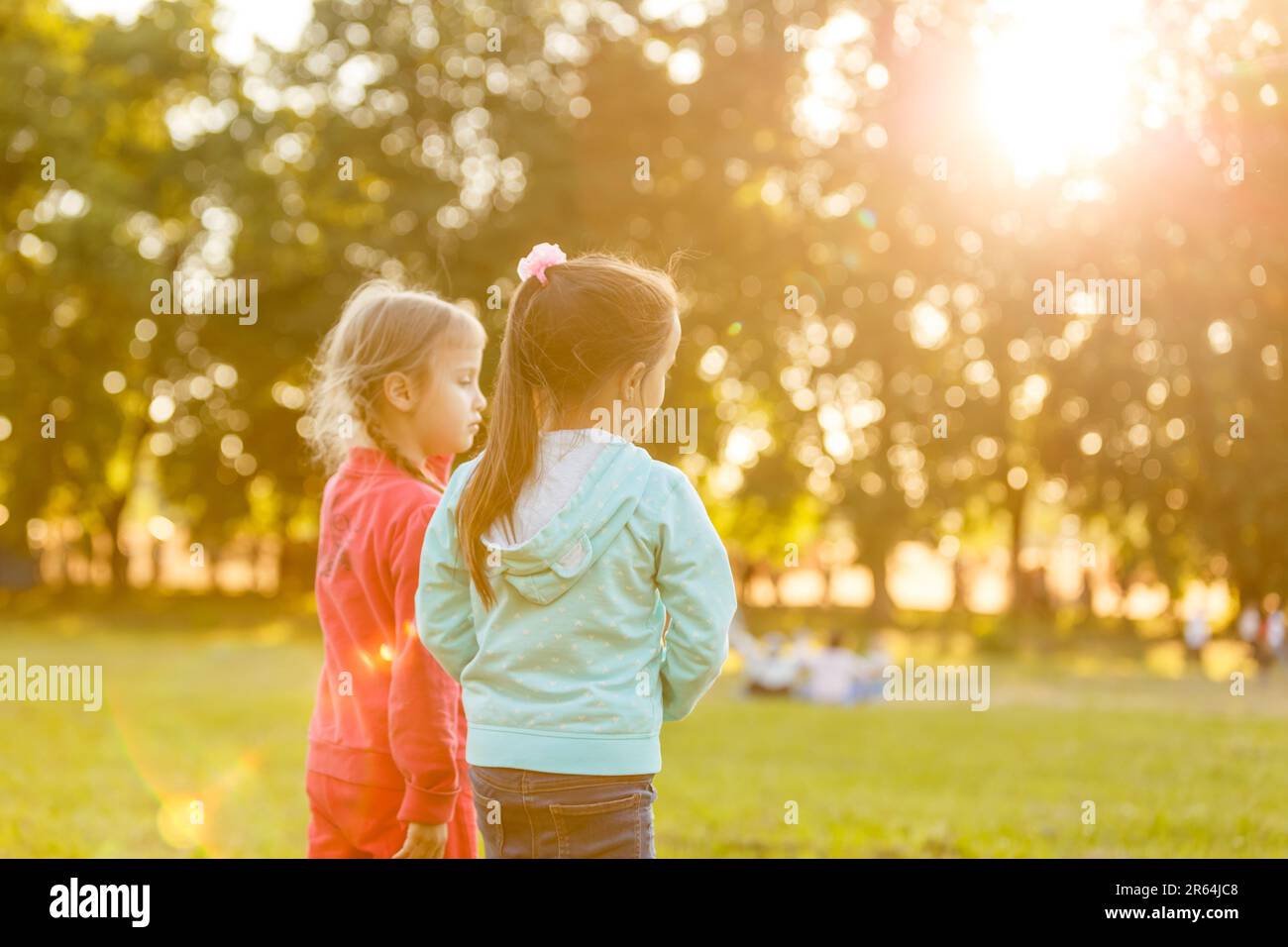 two little girls walking in the field Stock Photo - Alamy