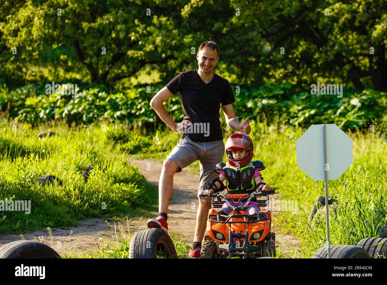 A child rides a quad bike through the mud. ATV rider rides Stock Photo ...