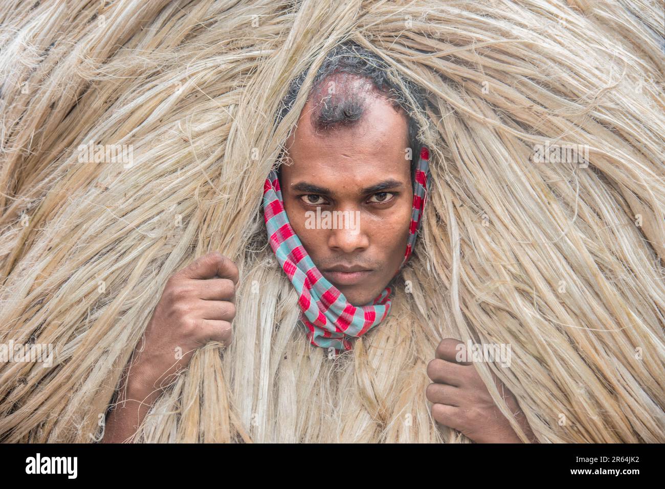 Manikganj, Dhaka, Bangladesh. 7th June, 2023. Workers carry huge piles ...