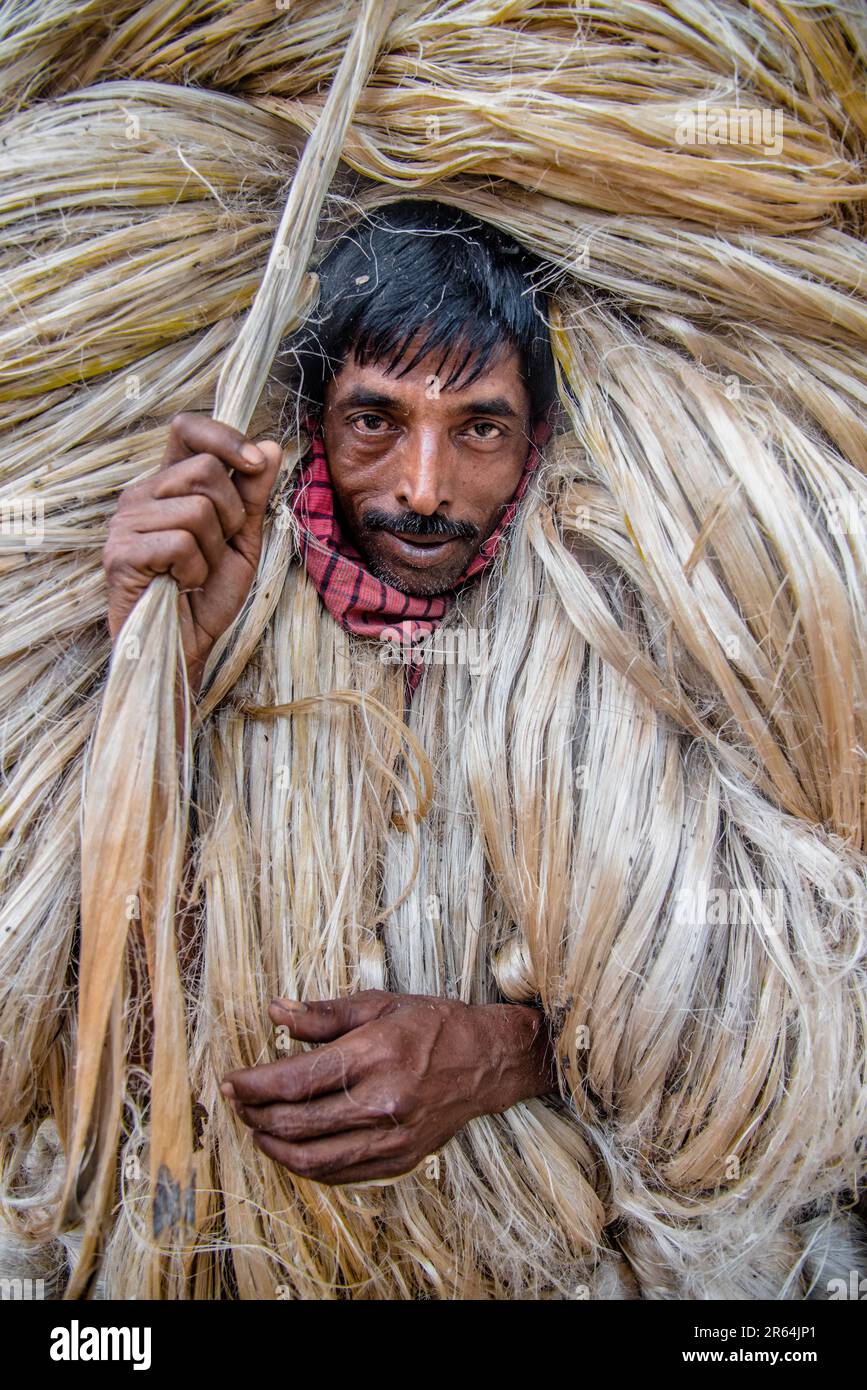 Manikganj, Dhaka, Bangladesh. 7th June, 2023. Workers carry huge piles ...
