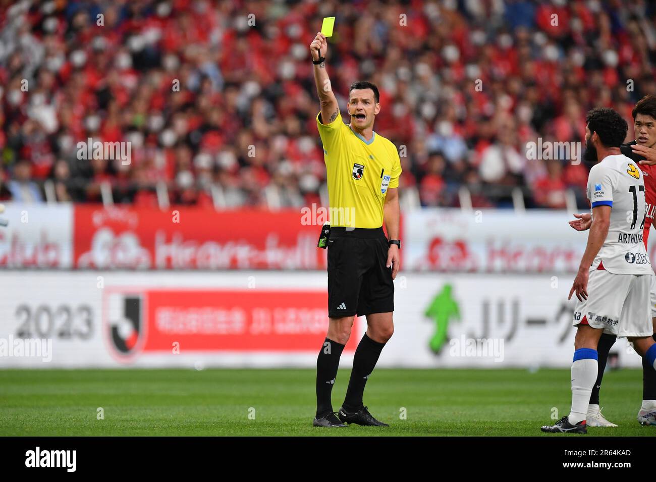 Referee Andrew Madley shows a yellow card during the 2023 J1 League ...