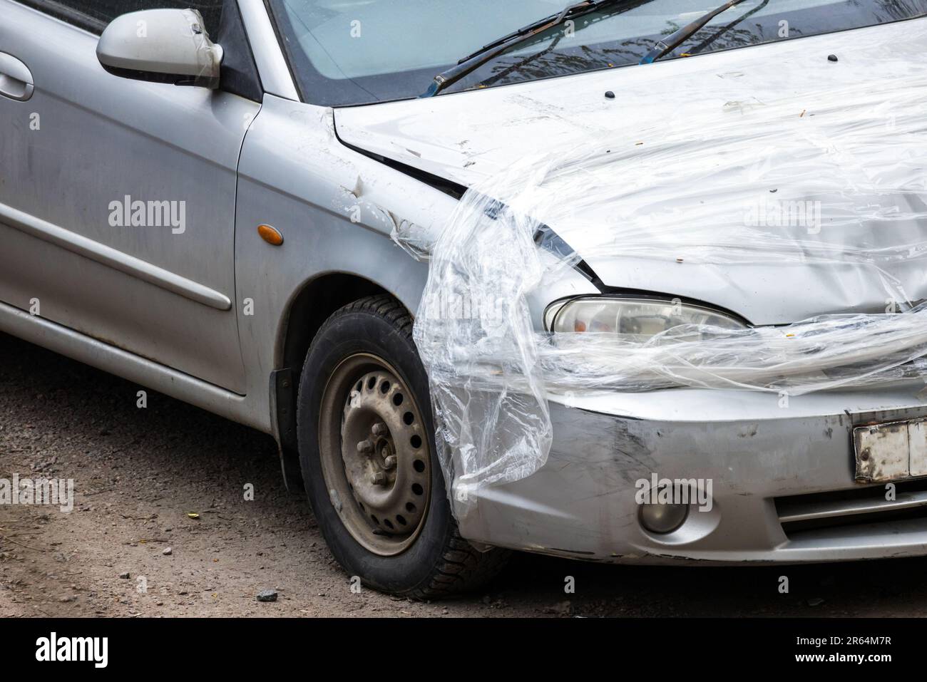 A crashed car, taped damaged front bumper, headlight and hood Stock ...