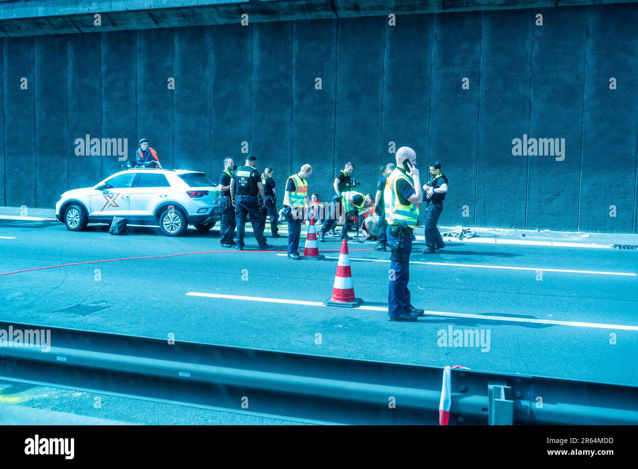 An activist got stuck on the roof of a car and Police officers detach ...