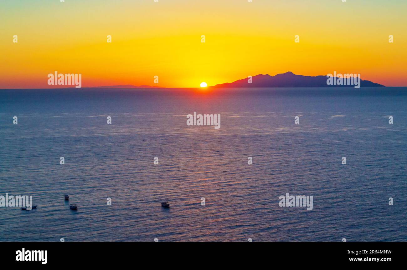 Sunrise over Aegean Sea,Anafi island in the distance and colorful dawn ...