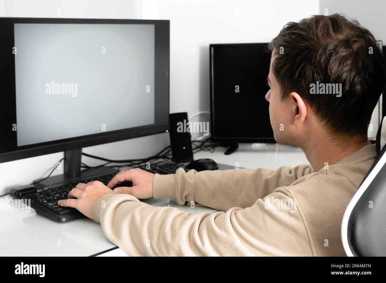 Rear view of a student using the computer Stock Photo - Alamy