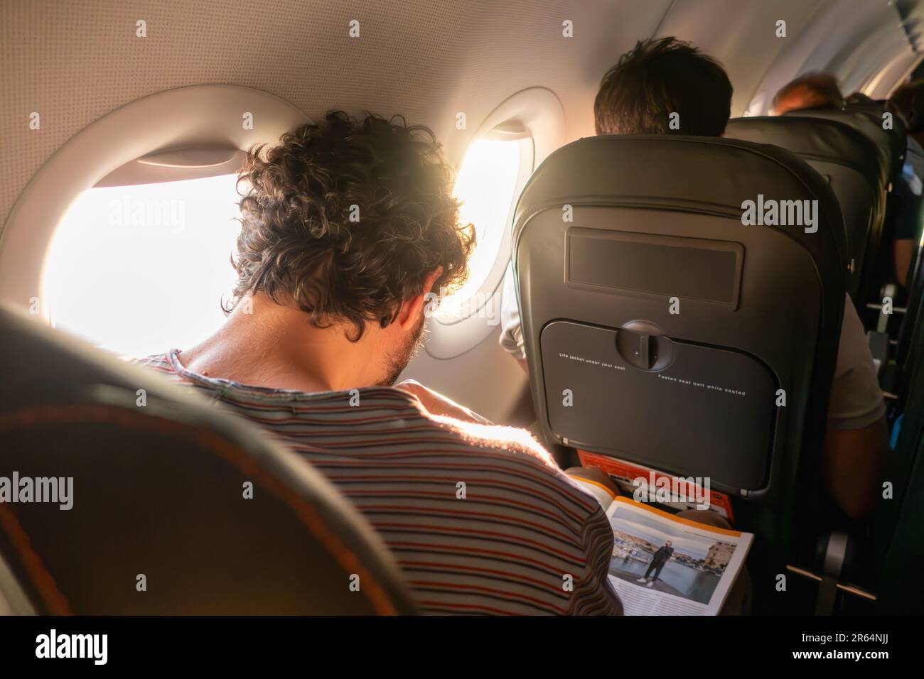 Passengers inside airplane. Plane interior with passenger. A Passenger ...