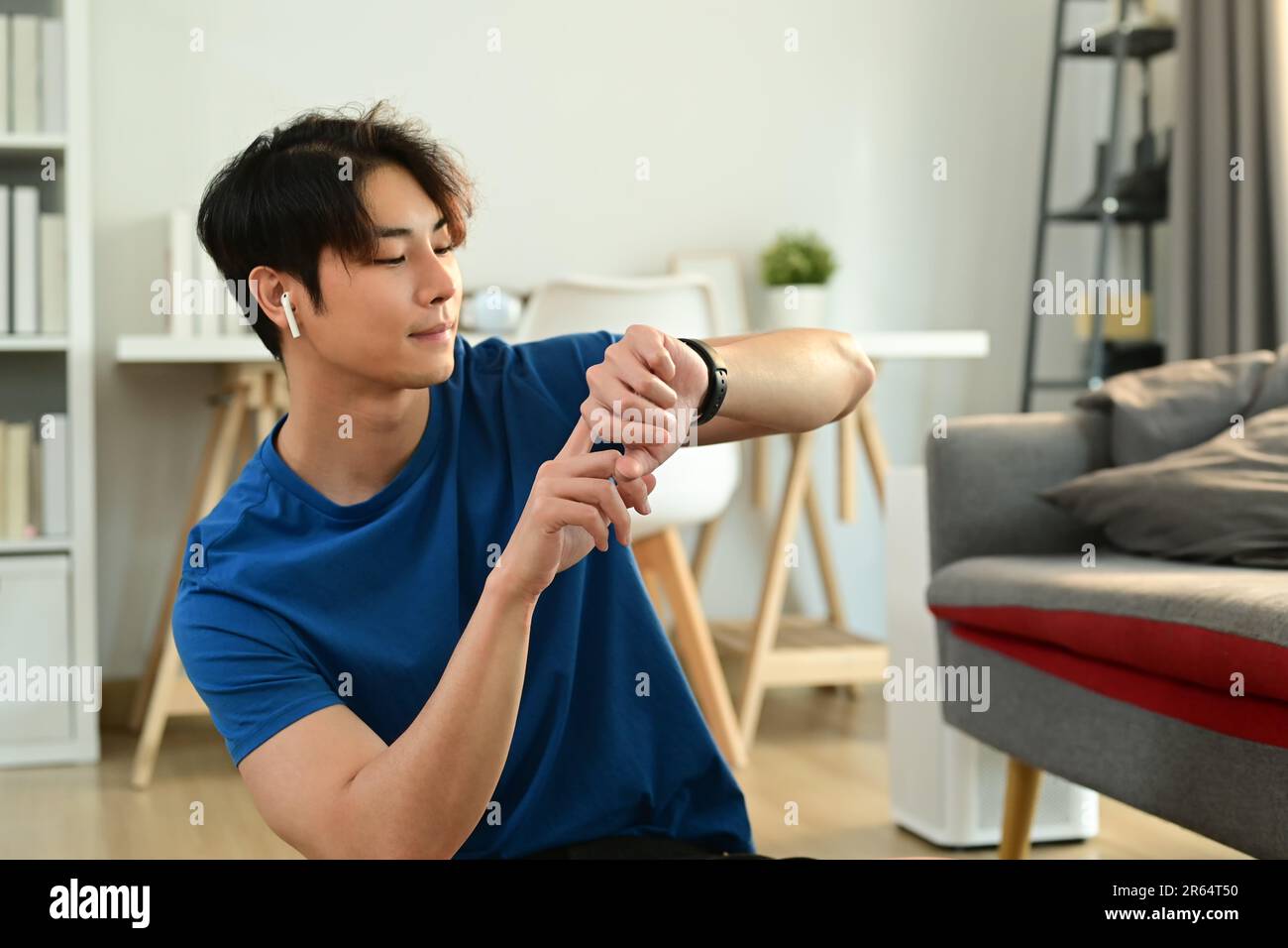 Active fitness man checking smartwatch to monitor training results ...