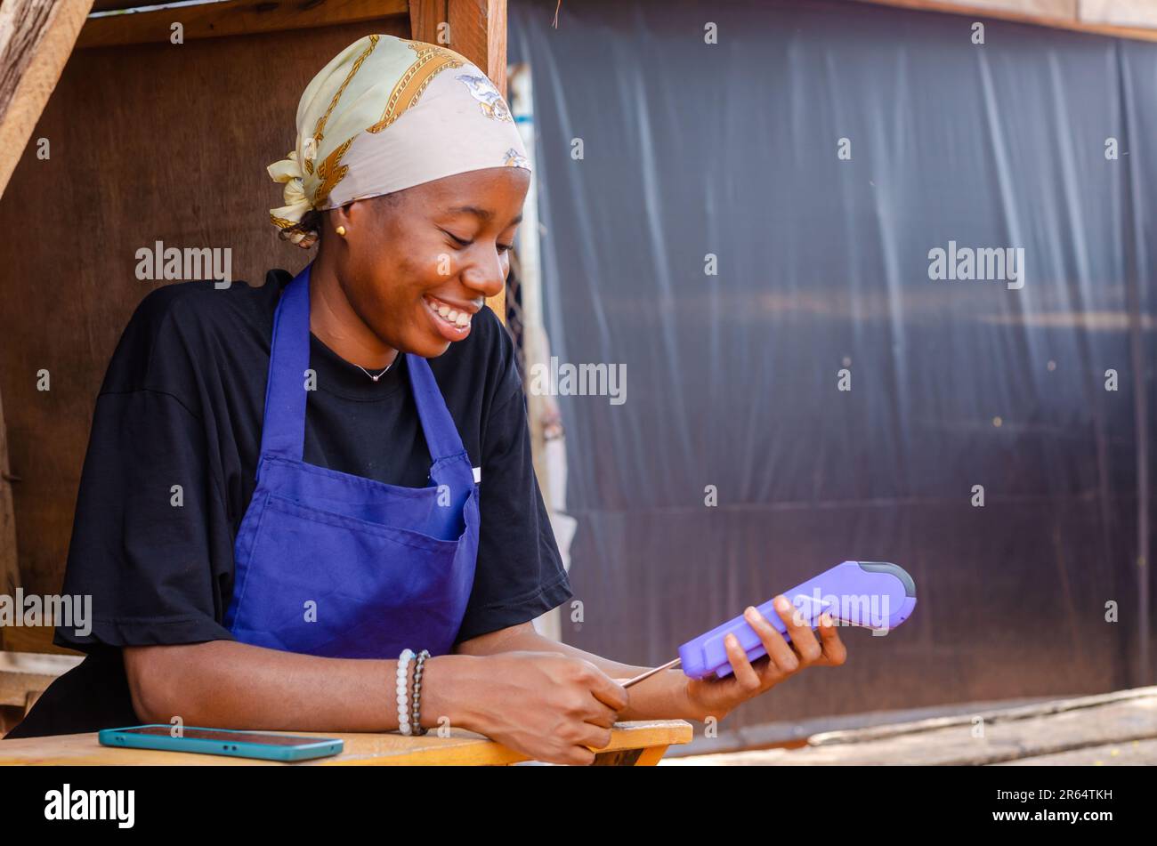 an african lady making use of her pos machine Stock Photo - Alamy