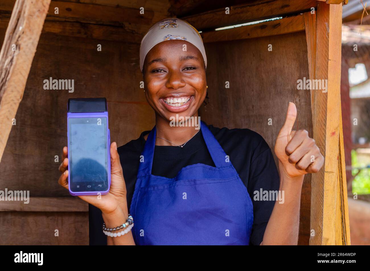 an african lady making use of her pos machine Stock Photo - Alamy