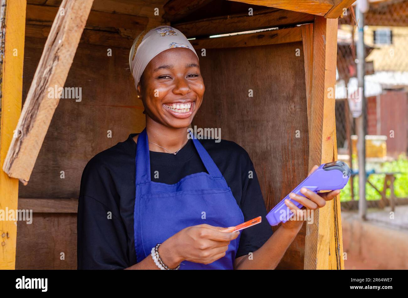 an african lady making use of her pos machine Stock Photo - Alamy