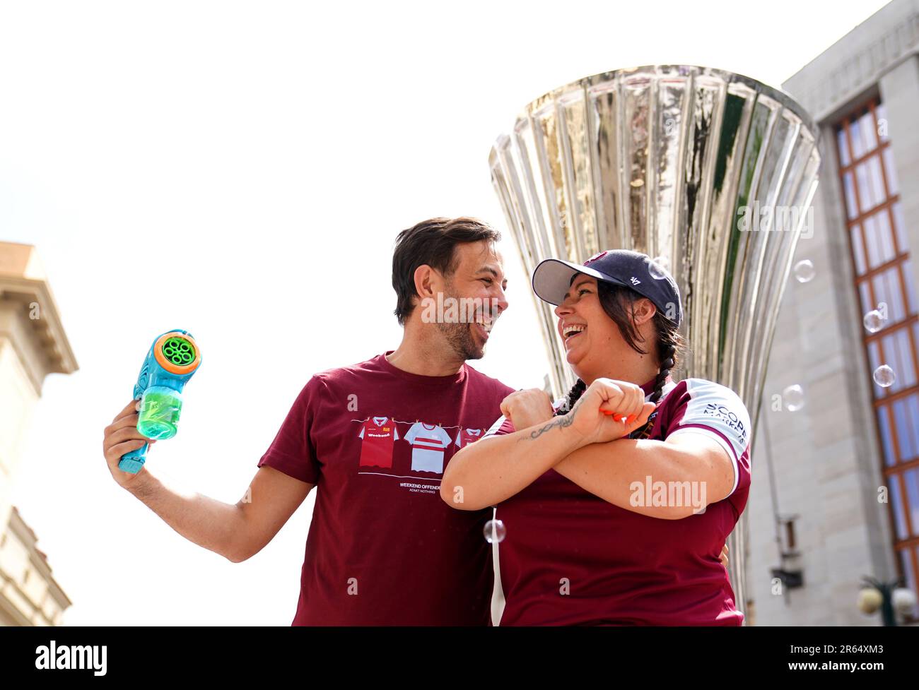 West Ham United fans pose for a photo in front of a large scale replica ...