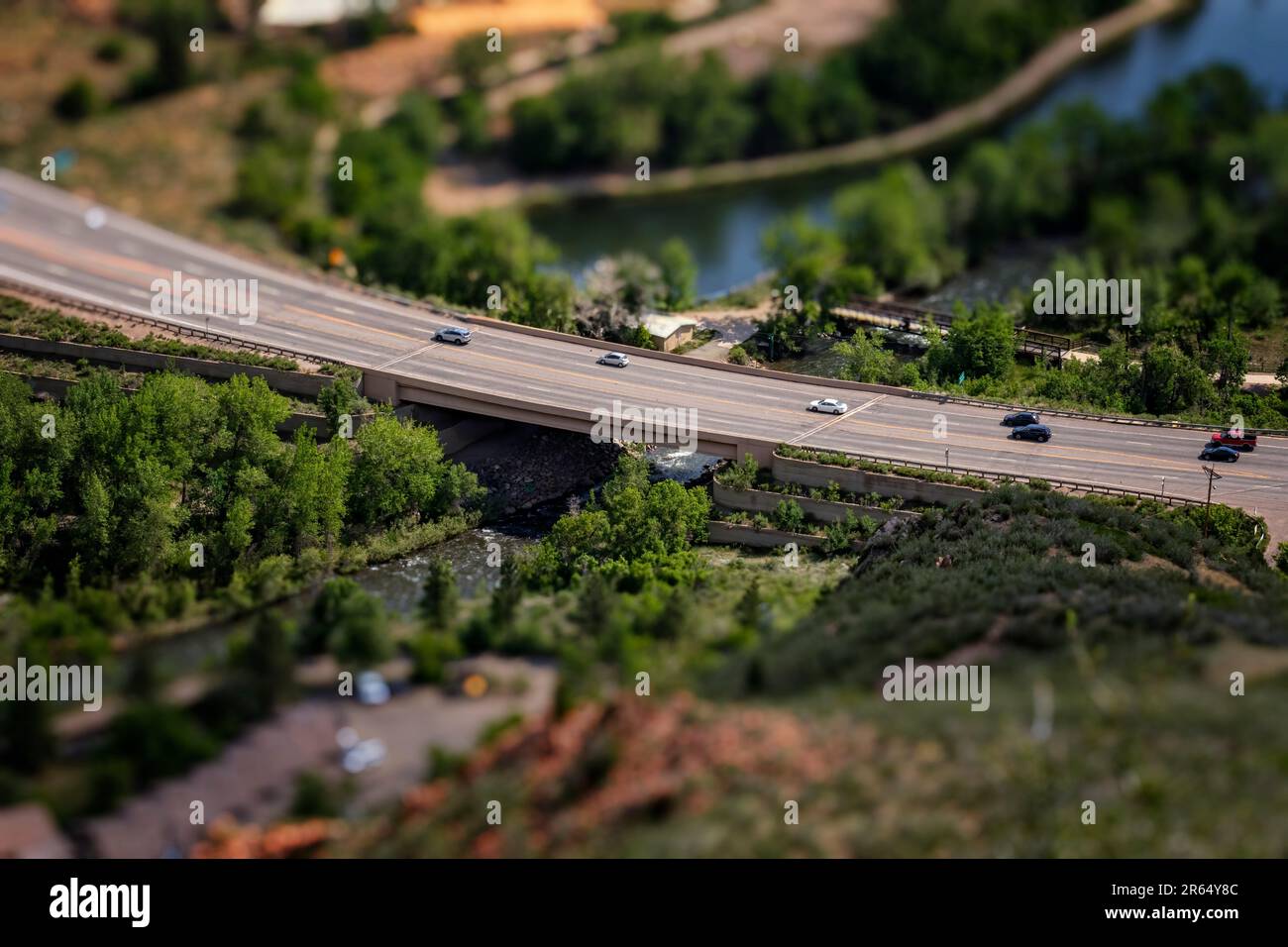 The cars driving on a bridge spanning a busy city street Stock Photo ...