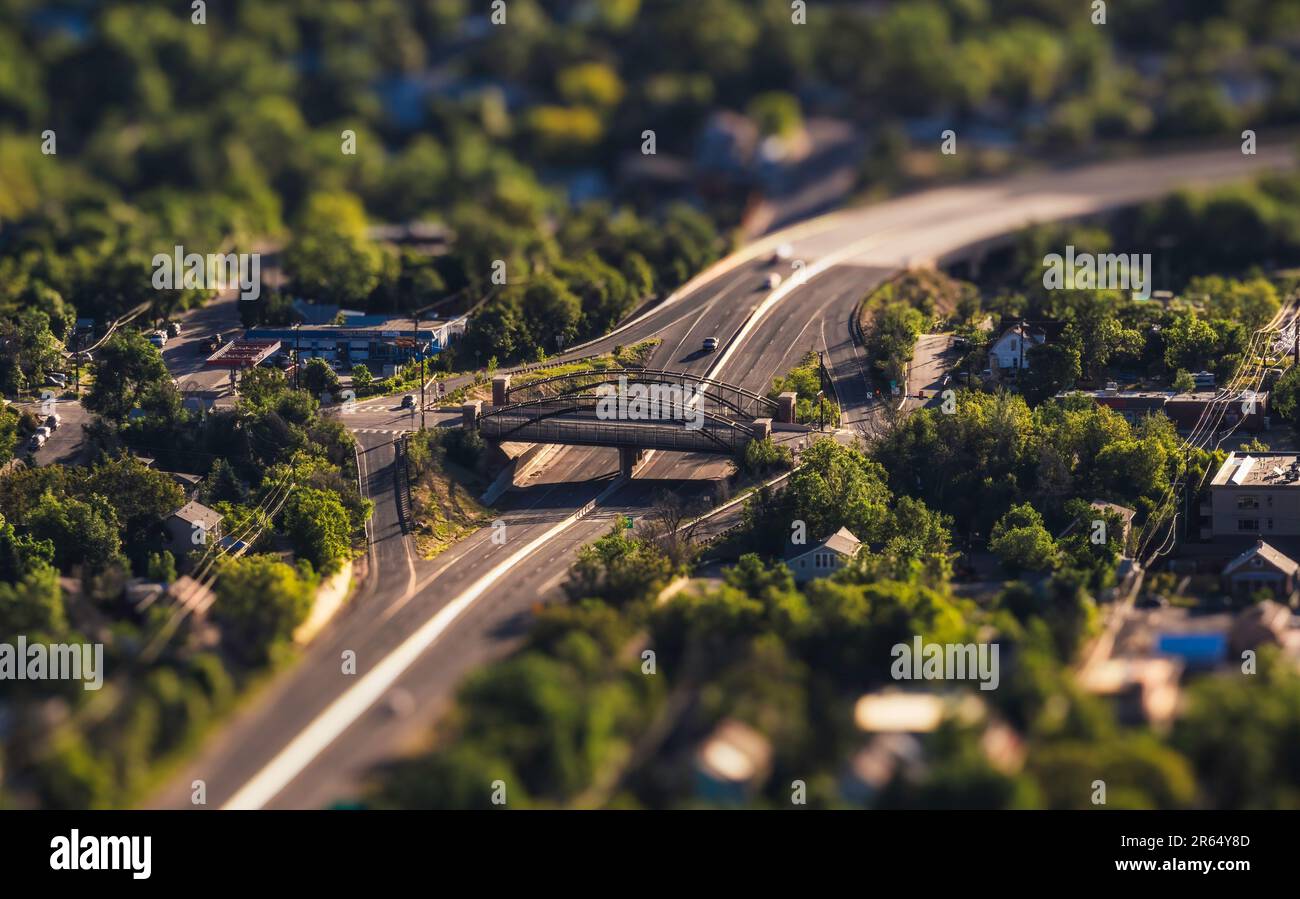 An aerial view of a bustling cityscape, with a winding road bridge ...