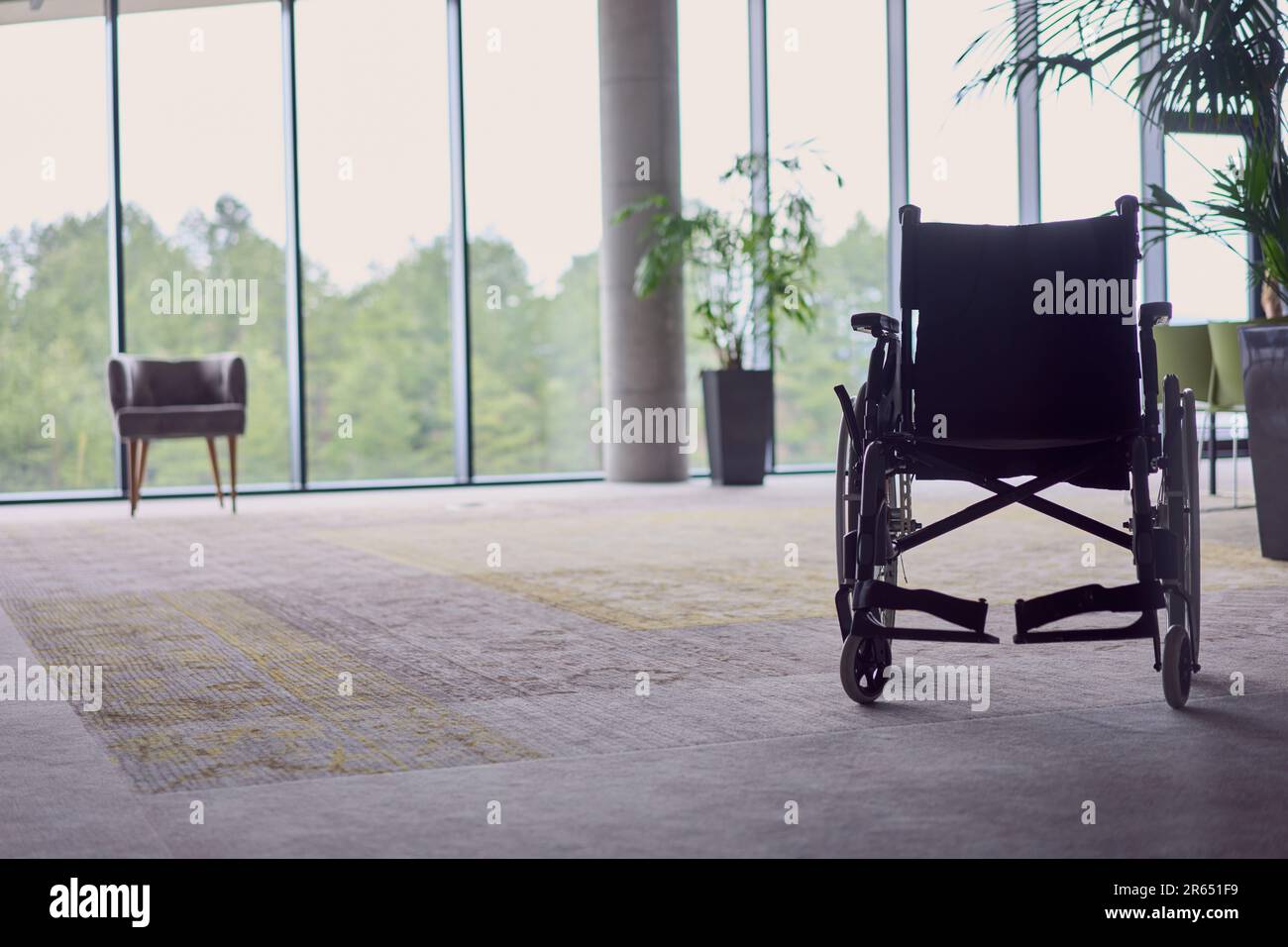 A wheelchair in a modern, spacious office, symbolizing inclusivity and ...