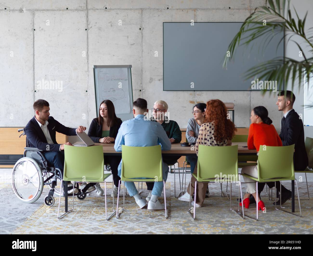 A diverse group of business professionals, including an person with a ...