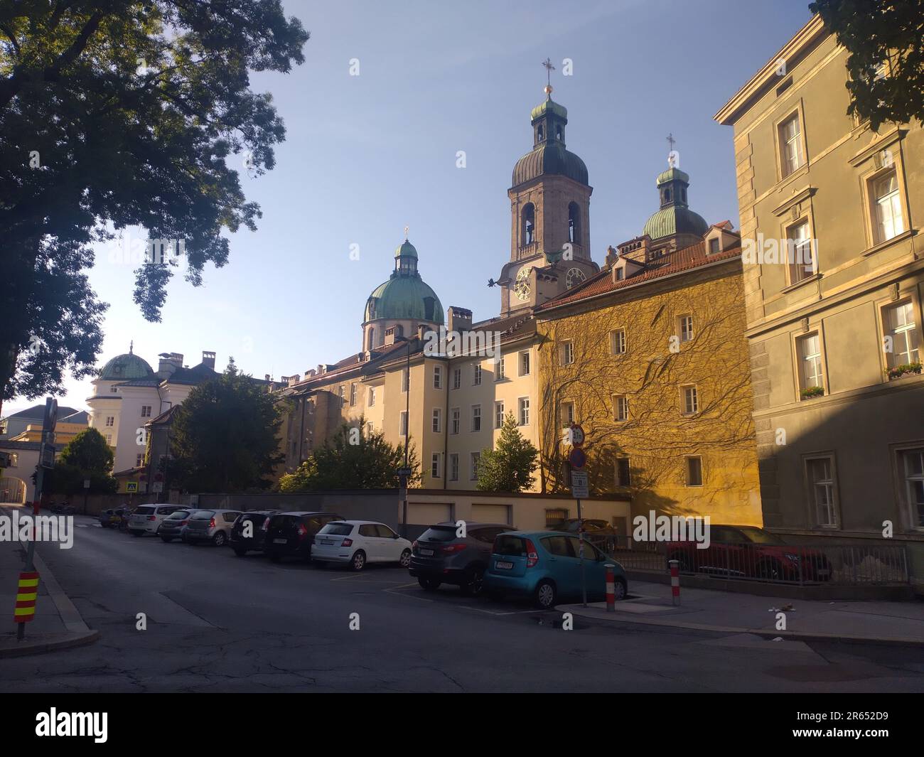 A busy urban street filled with tall structures and a church in ...