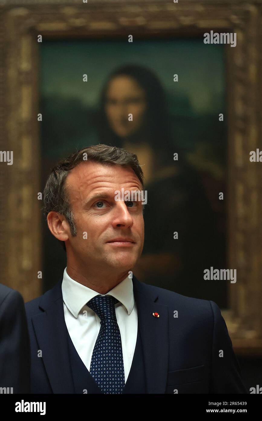 French President Emmanuel Macron watches paintings in front of Leonardo ...