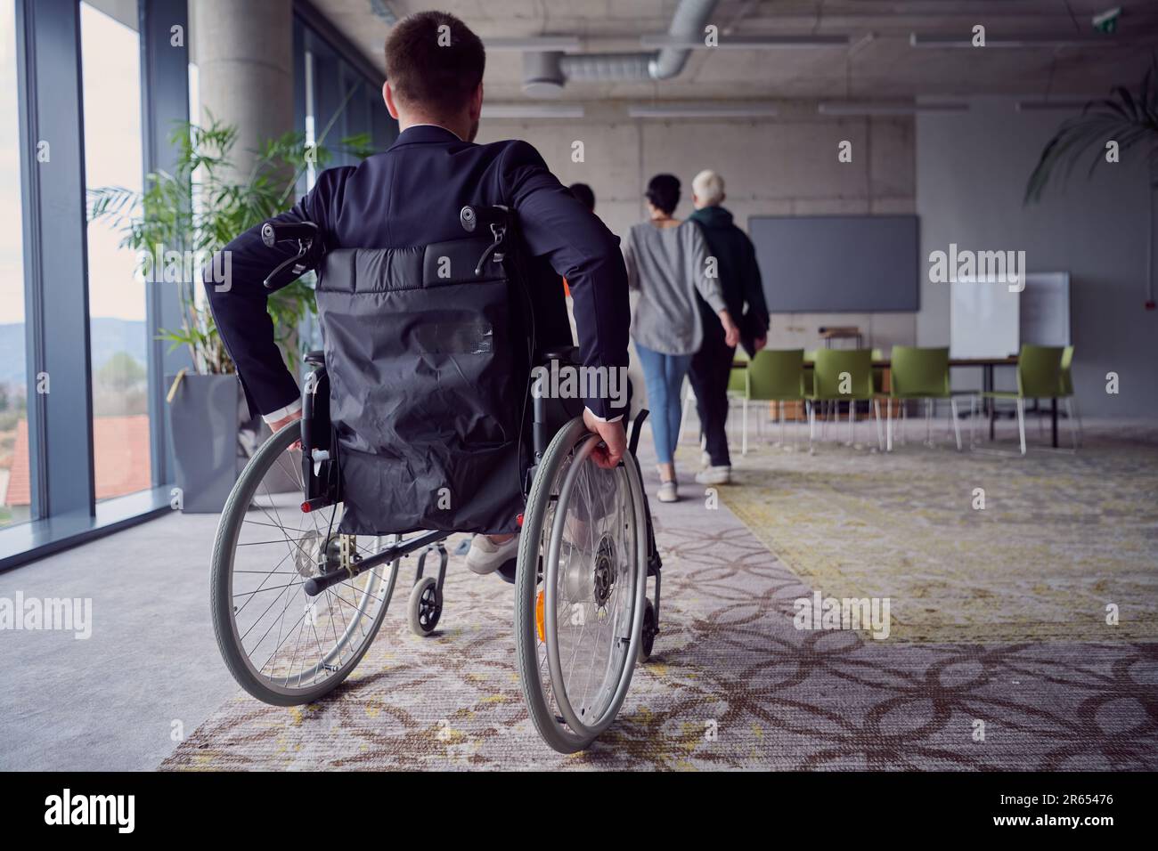 A diverse group of business professionals, including an person with a ...