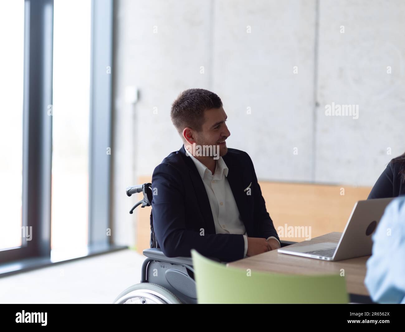 Closeup photo of a disabled person in a modern office at a productive ...