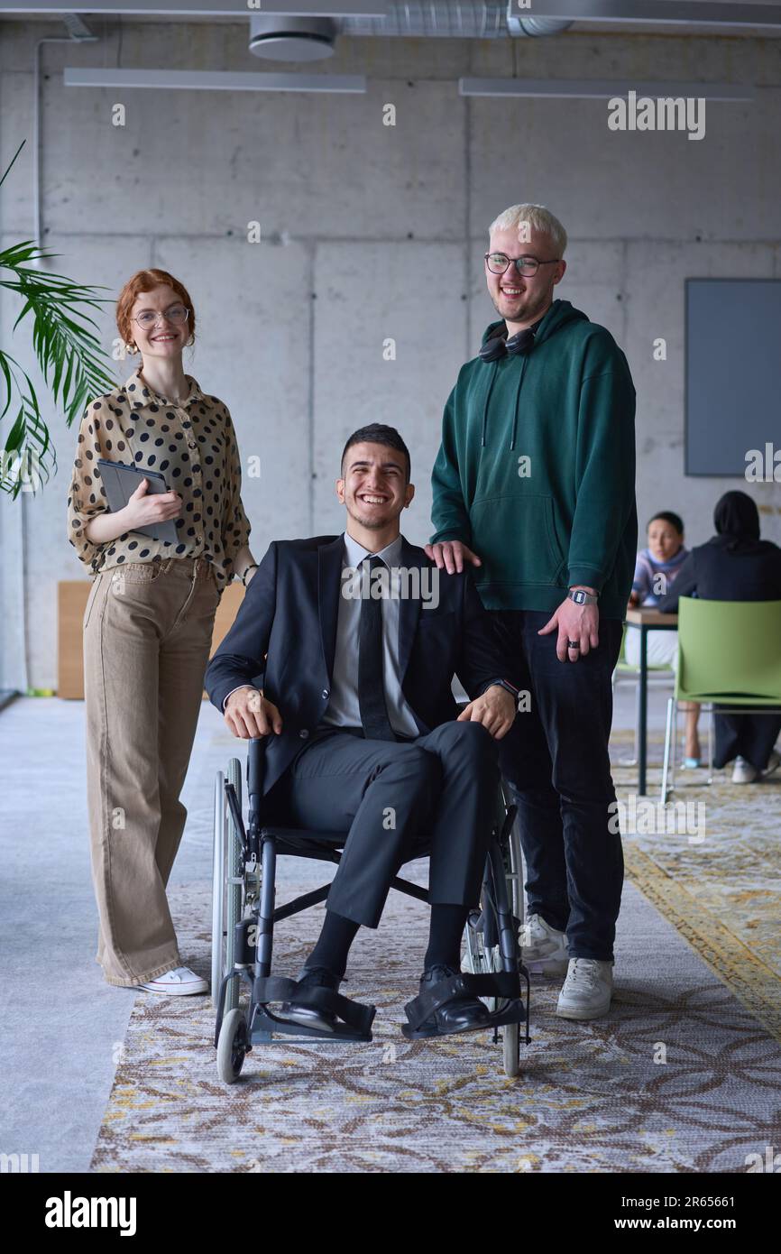 A businessman with disability in a wheelchair is surrounded by ...