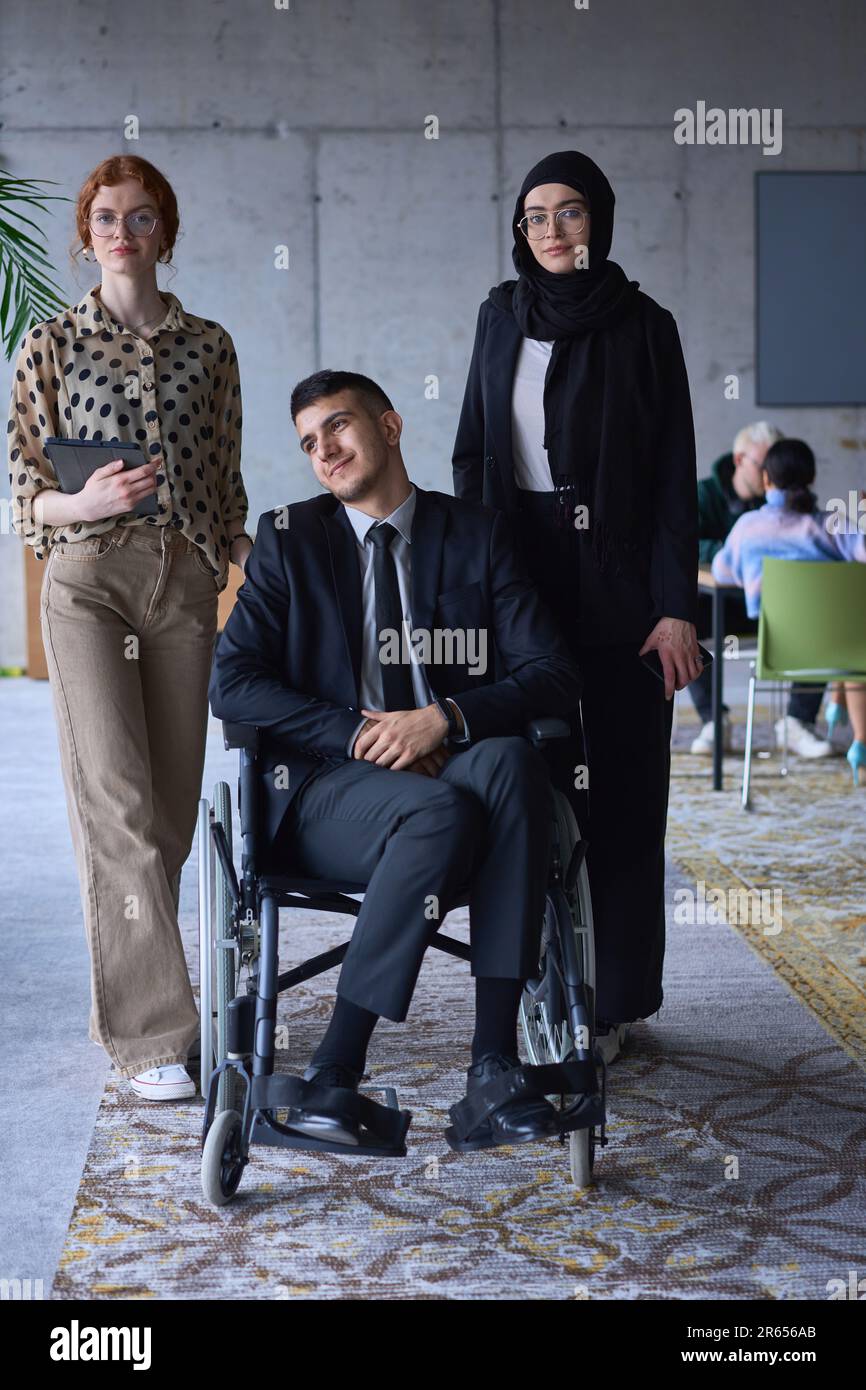 A businessman with disability in a wheelchair is surrounded by ...