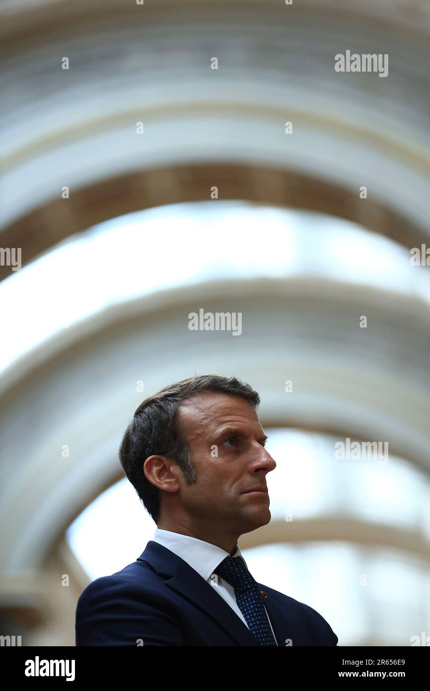 French President Emmanuel Macron looks at paintings as he visits the ...