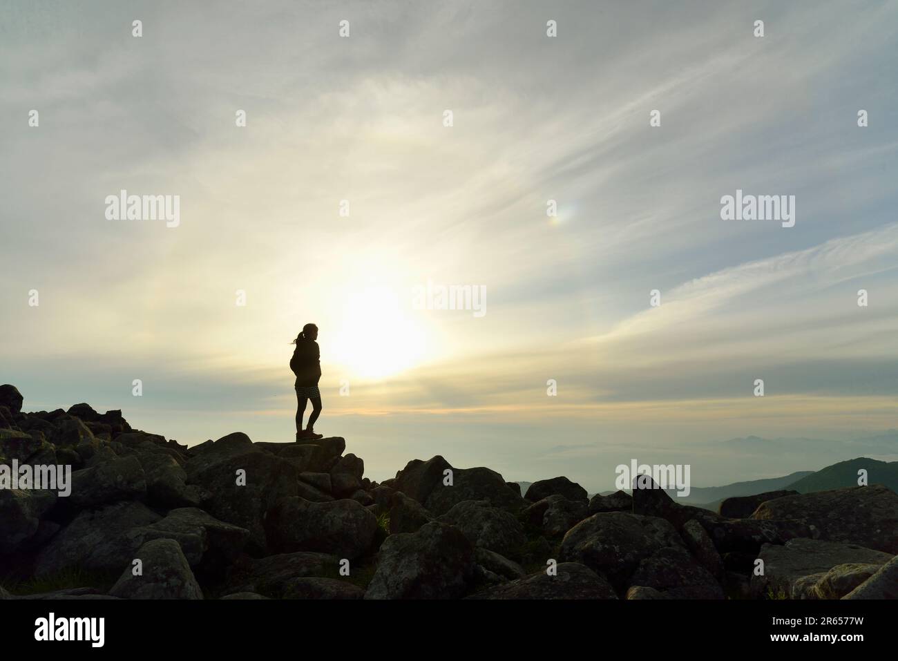Climber standing on the summit Stock Photo - Alamy