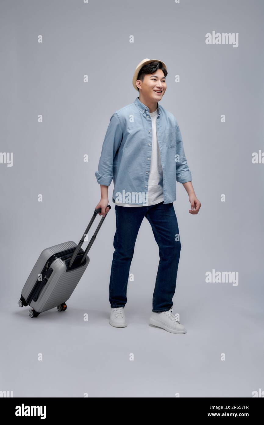 Traveler asian man standing with suitcase isolated over white ...