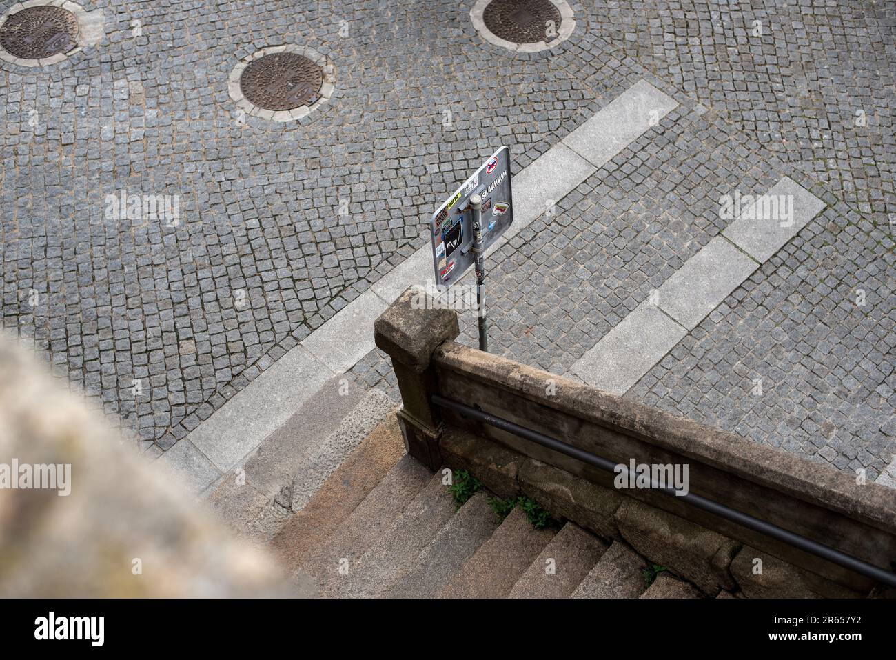 Top view of the street with paving stones, stone stairs and road sign ...