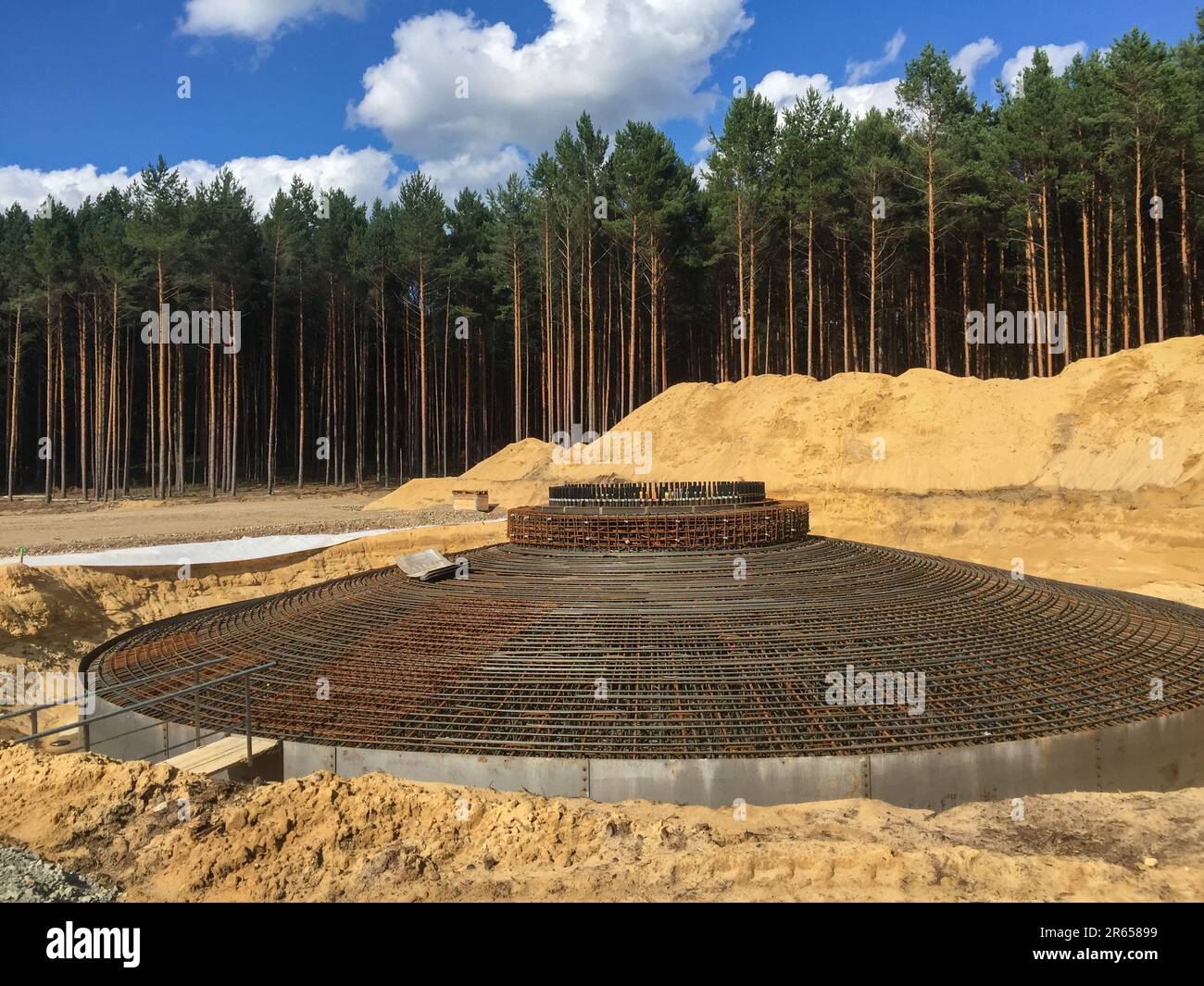 A concrete slab foundation in a forested area in front of a group of ...