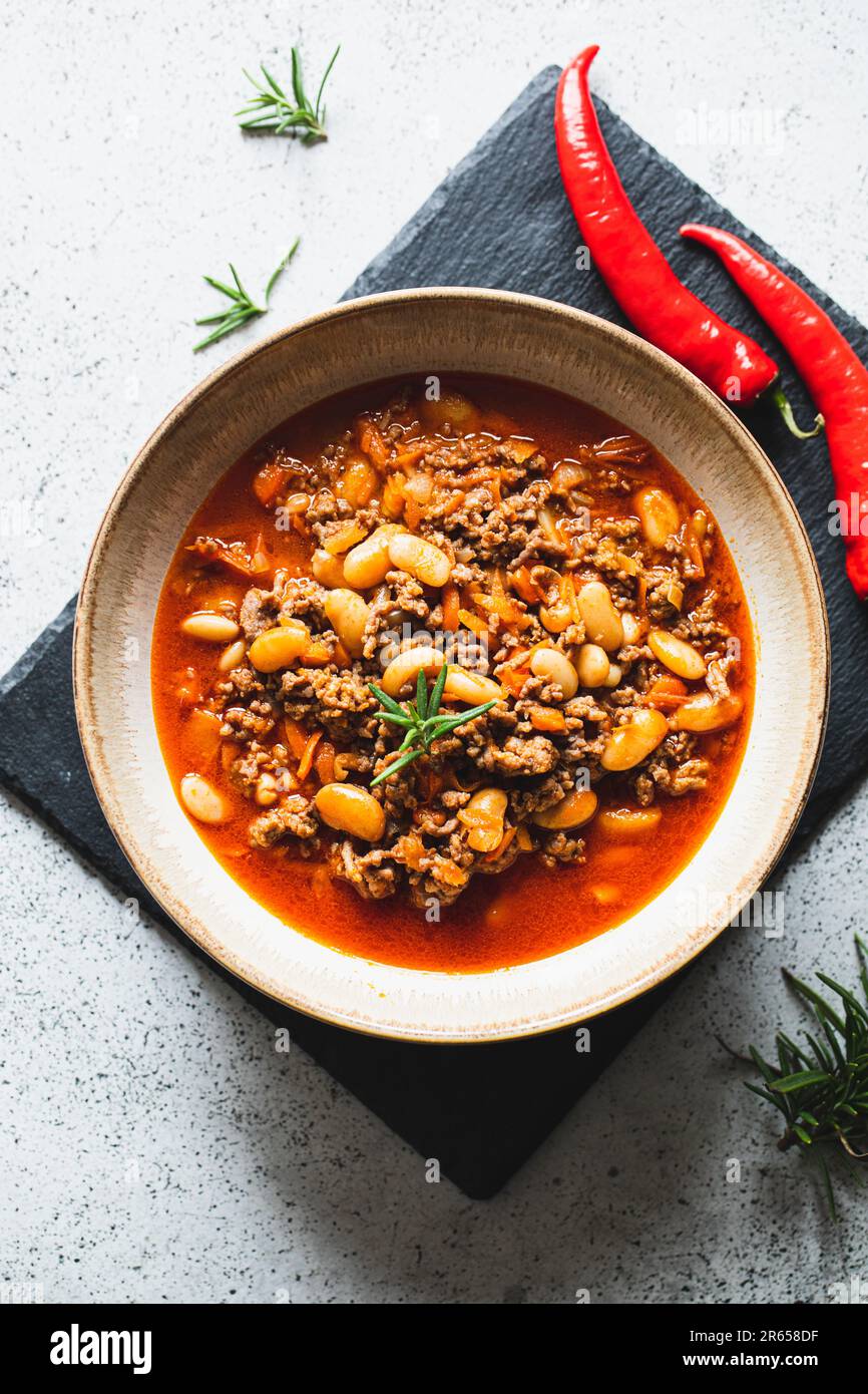 Chili Con Carne in bowl on light grey stone or concrete background ...