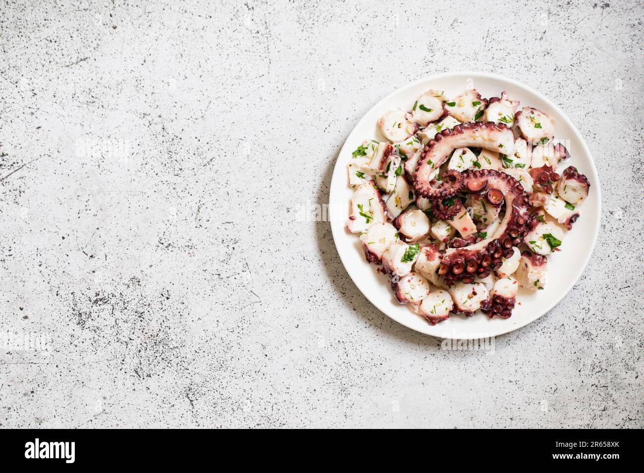 boiled chopped octopus on a concrete table Stock Photo - Alamy