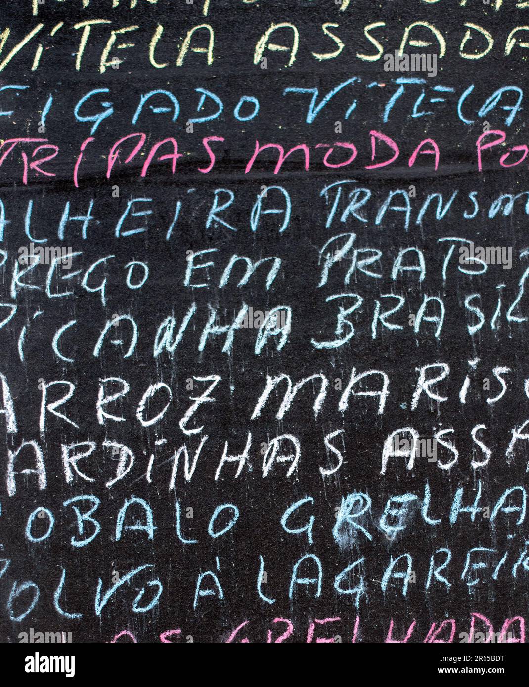 Detail of a portuguese menu written in multicolored chalk on a black ...