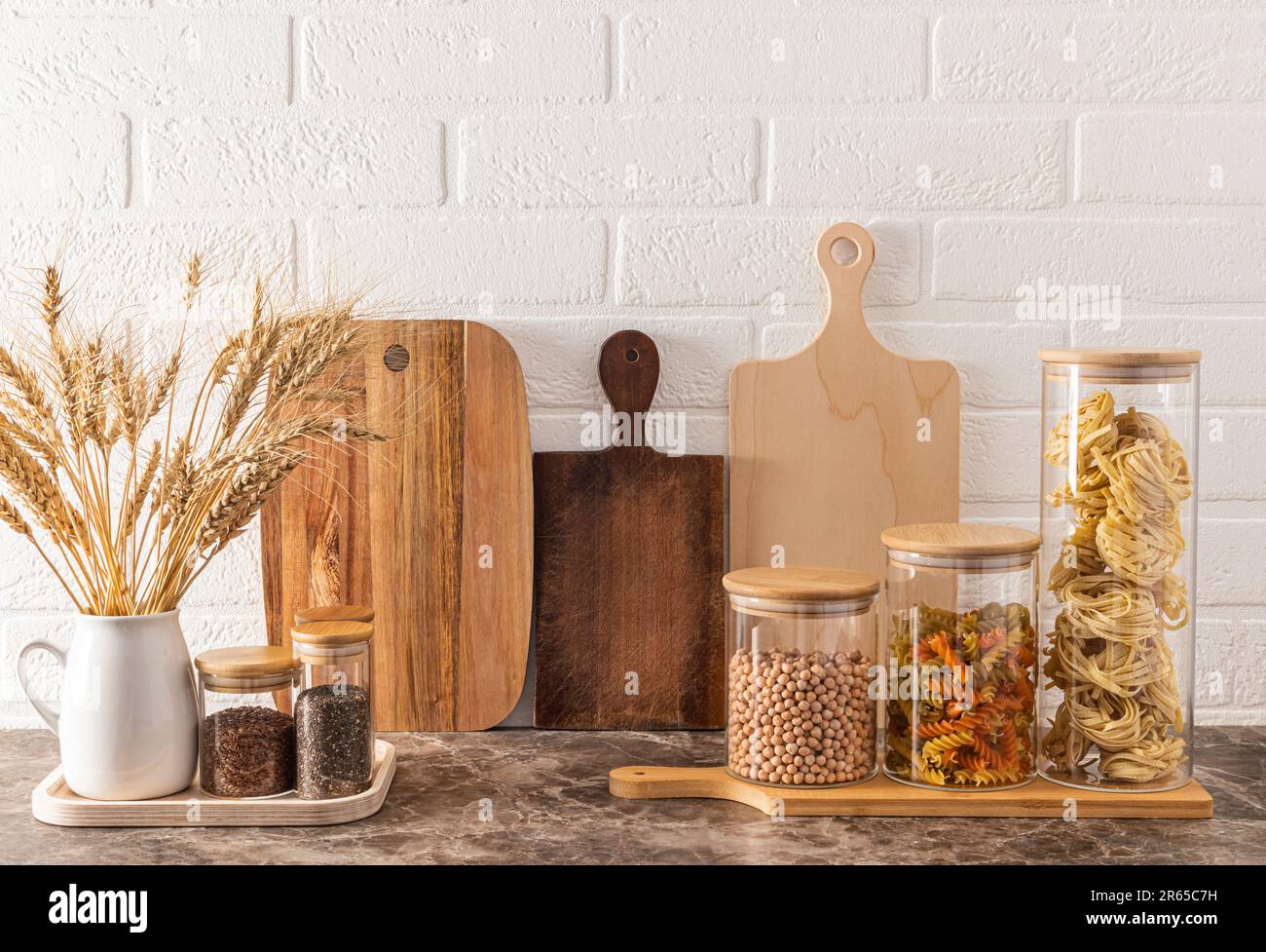 Front view of eco-friendly wood and glass kitchen utensils on a modern ...