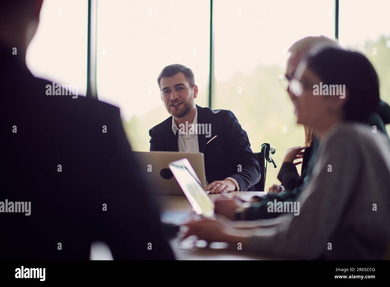 A diverse group of business professionals, including an person with a ...