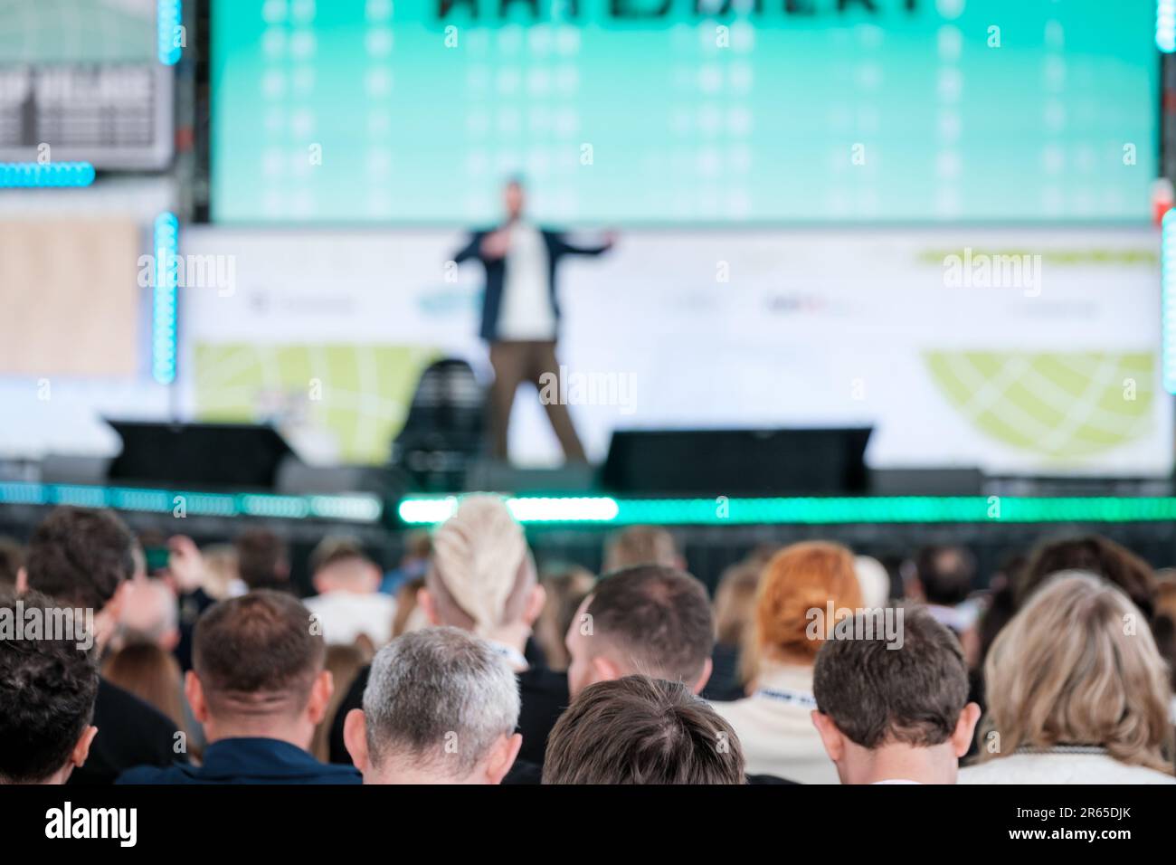 Back view of unrecognizable people in smart casual clothes sitting and ...