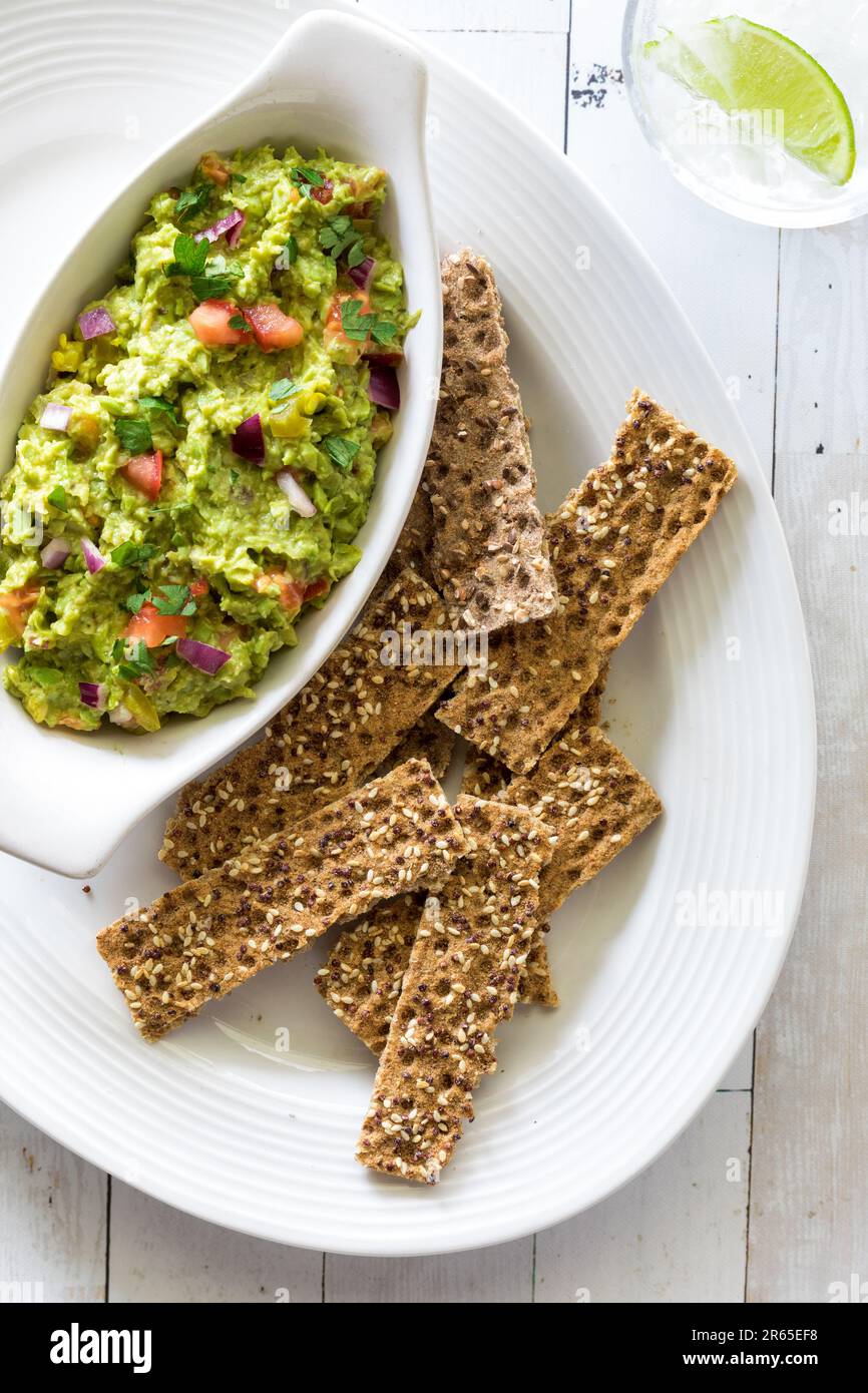 Rustic multi grain cracker sticks served with homemade guacamole Stock ...