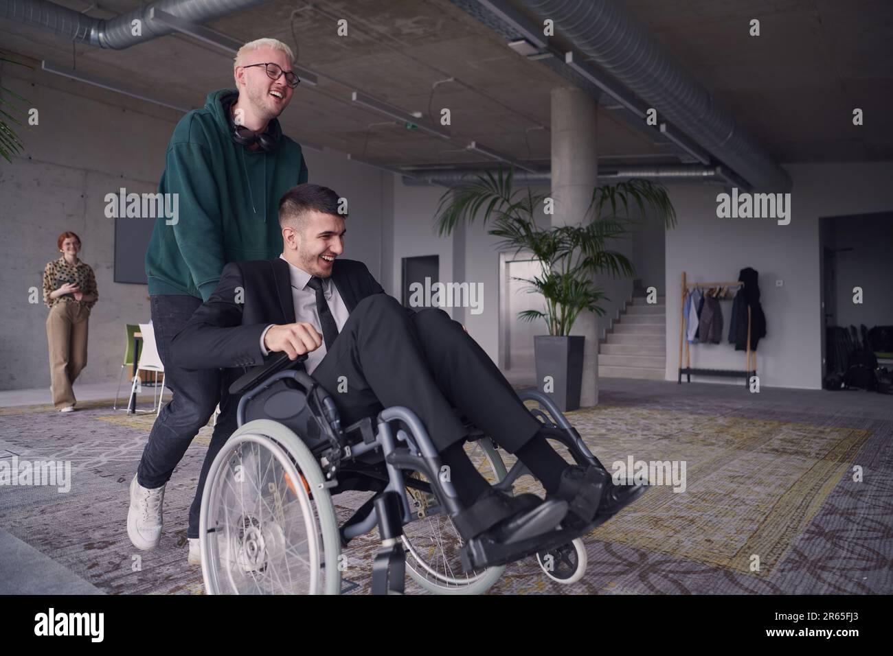 A young entrepreneur and his colleague, who is a person with a ...