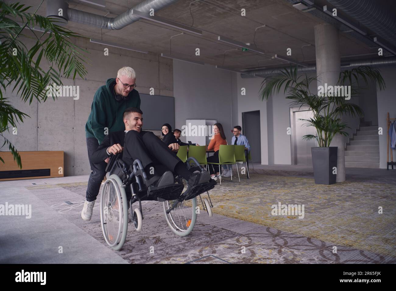 A young entrepreneur and his colleague, who is a person with a ...