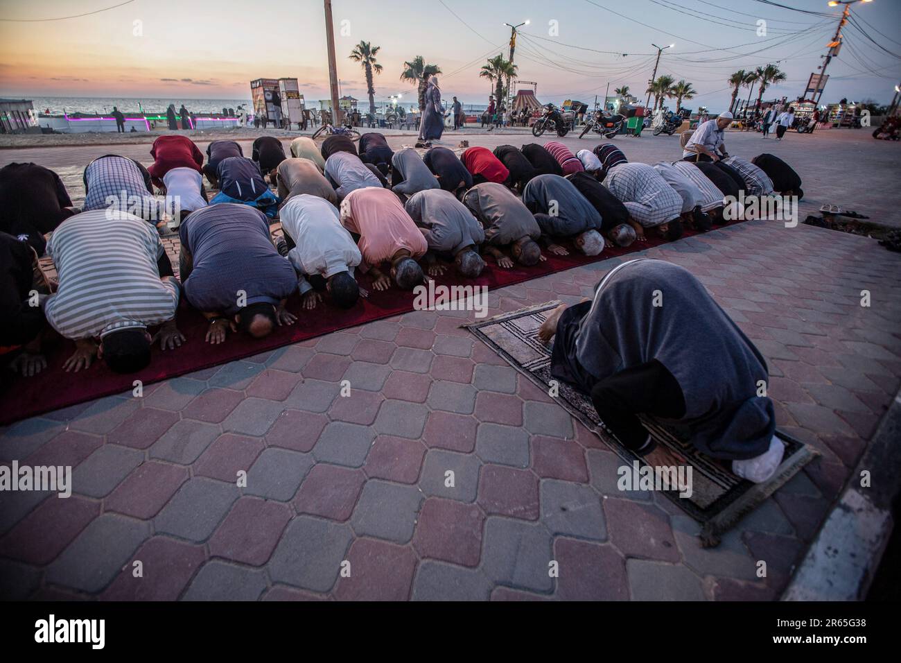 Palestinian Muslims perform maghrib prayers (sunset prayers) along the ...