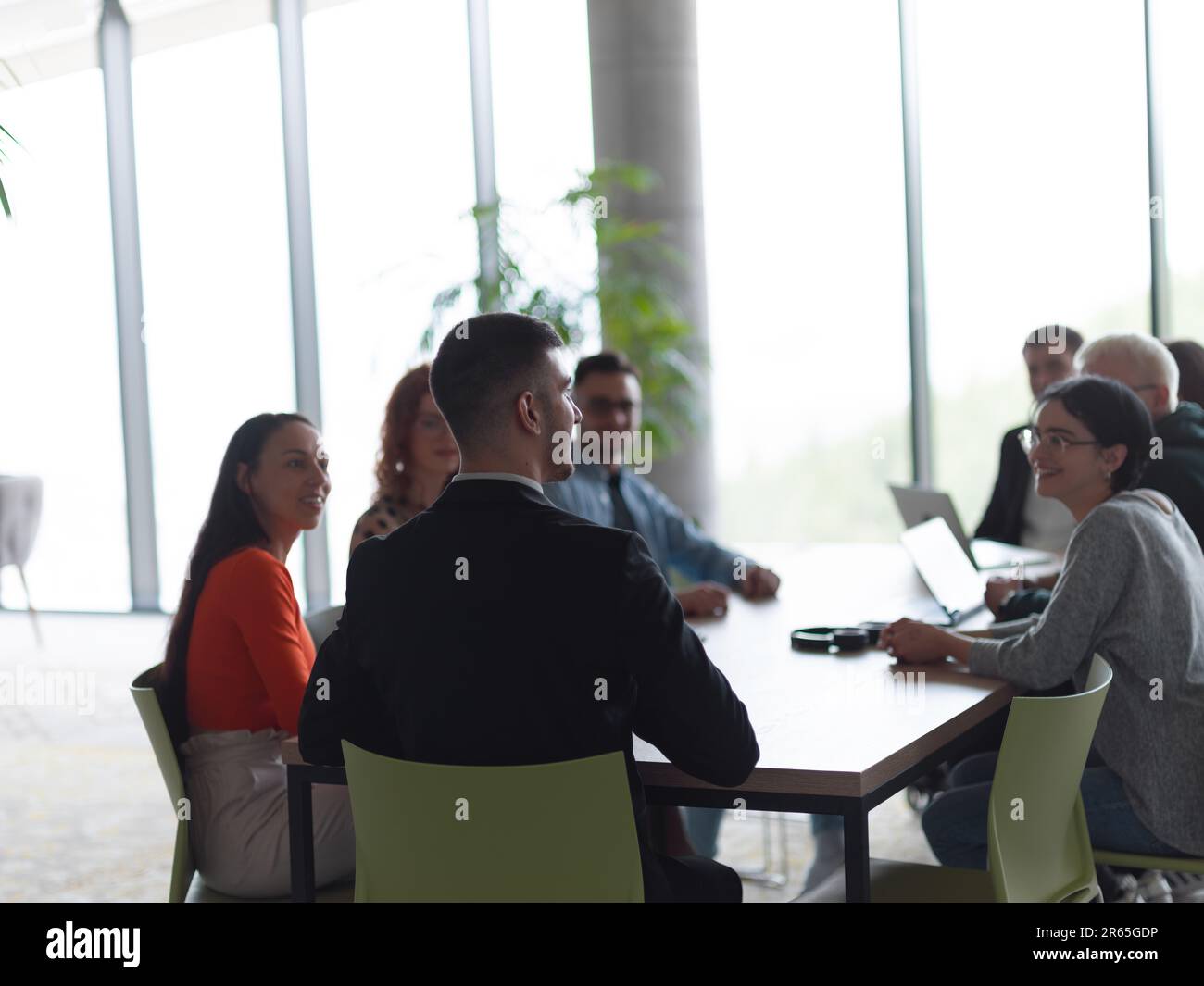 A diverse group of business professionals, including an person with a ...