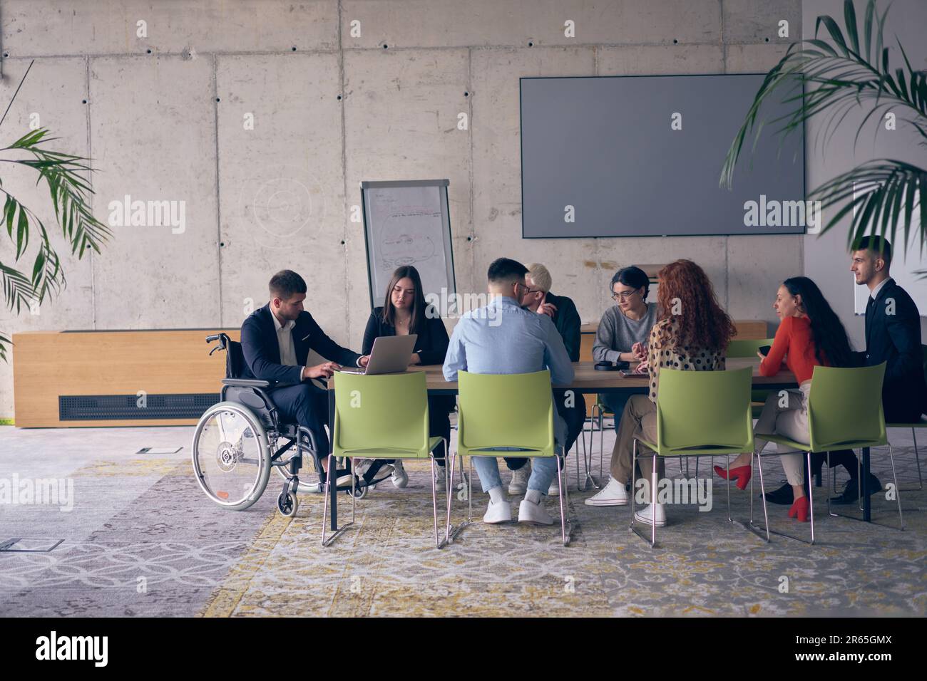 A diverse group of business professionals, including an person with a ...