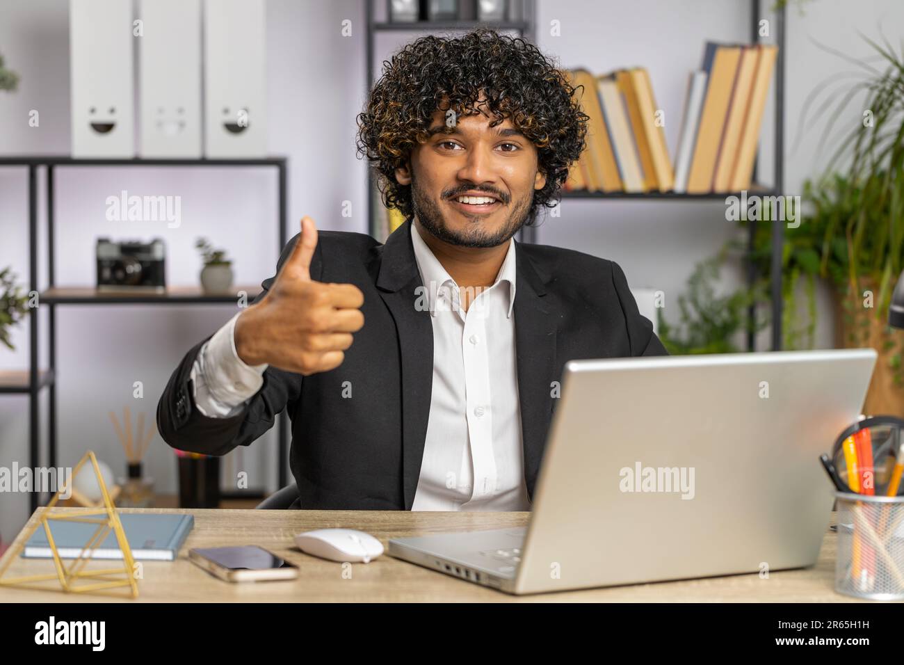Like. Happy young indian businessman guy working on laptop looking ...