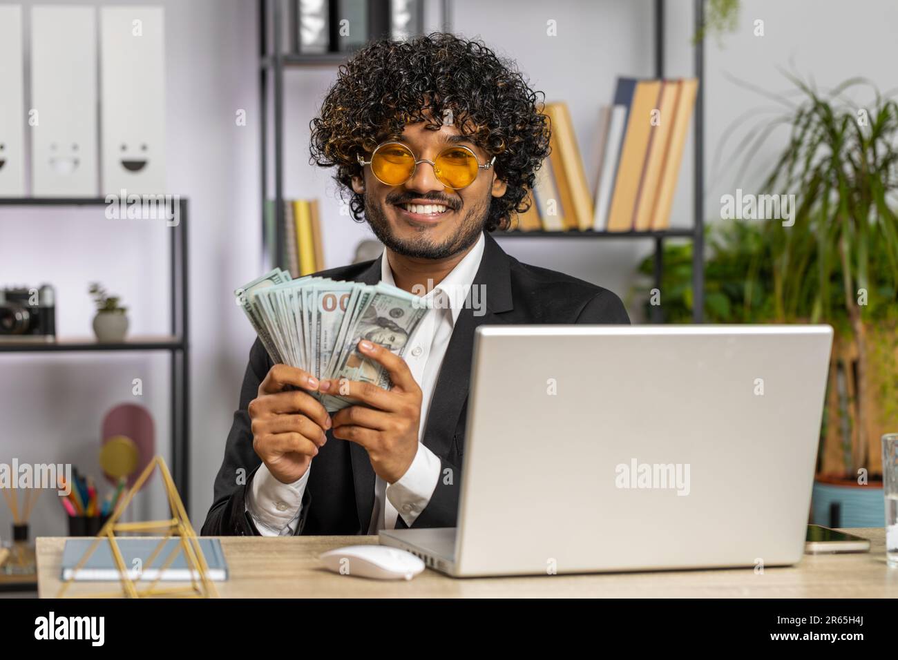 Indian businessman holding fan of cash money dollar banknotes celebrate ...